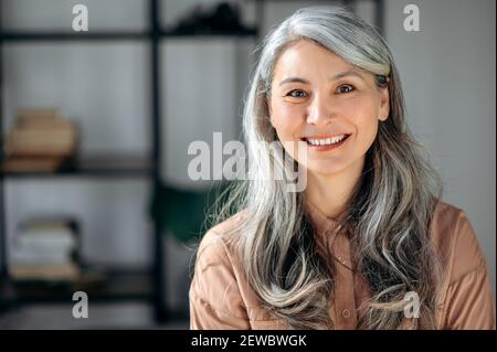adult gray-haired successful woman businesswoman on the background of ...