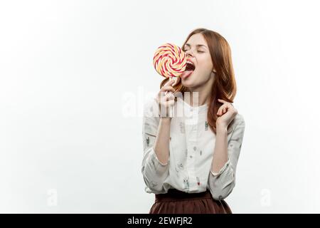 woman licking lollipop pleasure sweet candy joy Stock Photo - Alamy