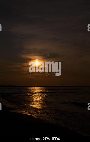 Beautiful view of the sea gleaming under the sunset in the cloudy blue ...