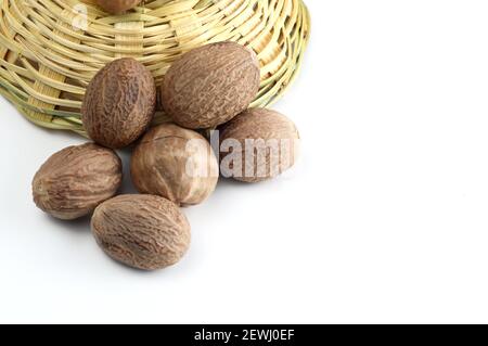 Nutmeg in bamboo basket isolated on white background Stock Photo - Alamy