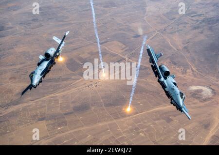 A U.S. Air Force A-10 Thunderbolt II dispenses a flare during a flight ...