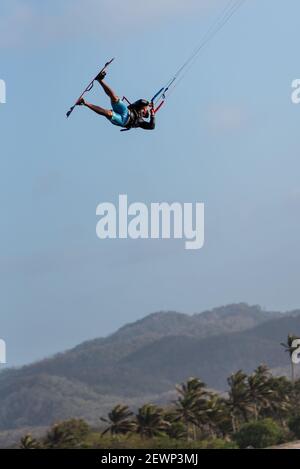 Man kiteboarder performing kitesurfing unhooked tricks, boy kitesurfer ...
