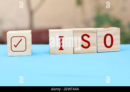 The abbreviation ISO on wooden cubes with check mark on white ...