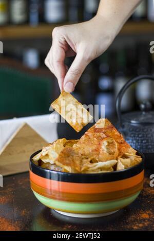 A vertical closeup shot of crunchy nacho chips in a bowl Stock Photo ...
