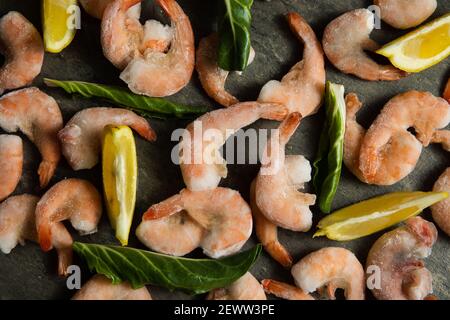 food square background - frozen boiled red shrimps and fish close up ...