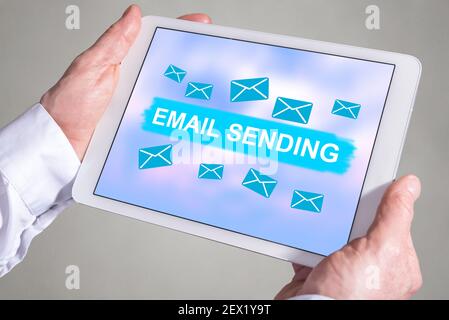 Tablet screen displaying an email sending concept Stock Photo - Alamy