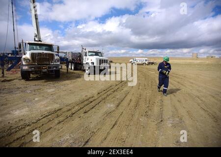 Schlumberger trucks with 2000 horsepower pumps direct water, sand and ...