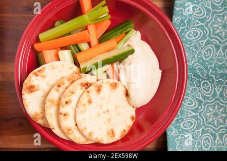 home made hummus or hummous with naan bread and vegetable sticks Stock ...