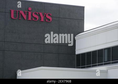 A logo sign outside of the headquarters of Unisys Corporation in Blue ...