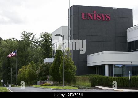 A logo sign outside of the headquarters of Unisys Corporation in Blue ...