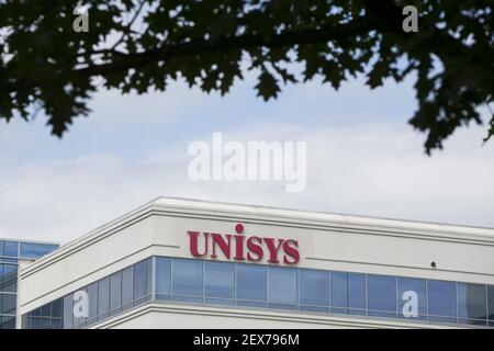 A logo sign outside of the headquarters of Unisys Corporation in Blue ...