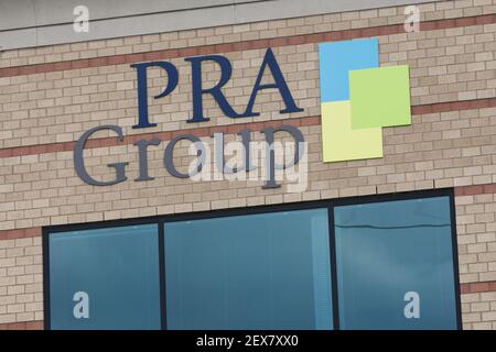 A logo sign outside of the headquarters of the PRA Group, Inc., also ...