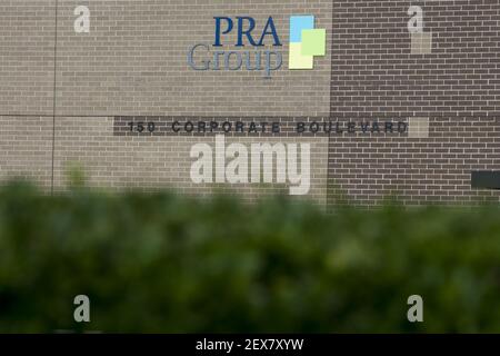 A logo sign outside of the headquarters of the PRA Group, Inc., also ...