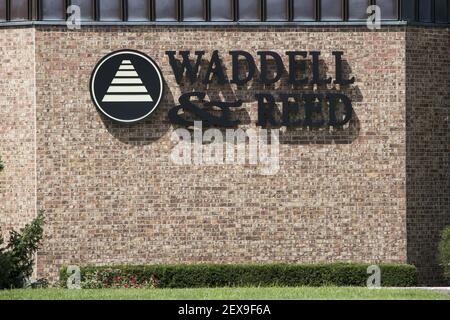 A logo sign outside of the headquarters of Waddell & Reed Financial ...