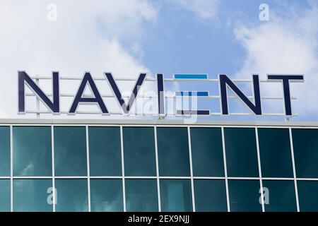 A logo sign outside of the headquarters of the Navient Corporation in ...