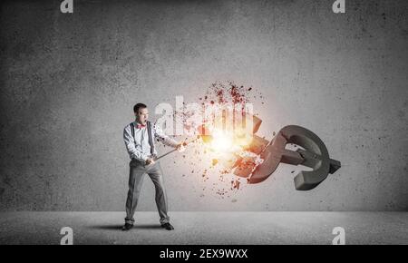 Determined banker man in empty concrete room breaking dollar figure ...