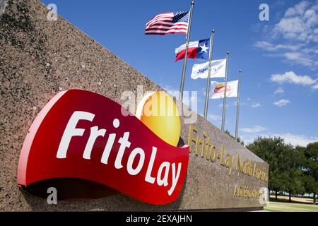 A logo sign outside of the headquarters of Frito-Lay, Inc., a ...
