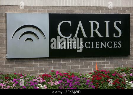 A logo sign outside of the headquarters of Caris Life Sciences in ...