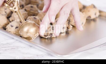 Step by step. Scooping homemade chocolate chip cookies with metal dough ...