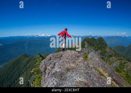 A man climbs a mountain in the Colonel Bob Wilderness on the Olympic ...
