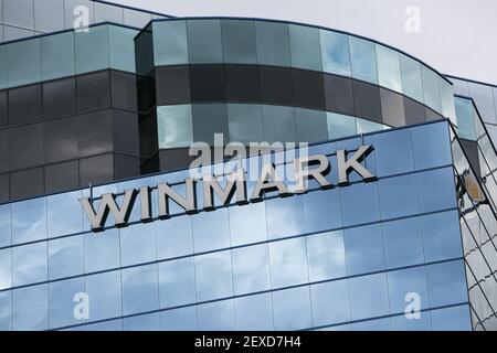 A logo sign outside of the headquarters of the Winmark Corporation in ...