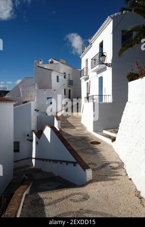 A vertical shot of a narrow pretty alley going through buildings and ...