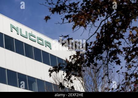 A logo sign outside of the headquarters of the Nucor Corporation in ...