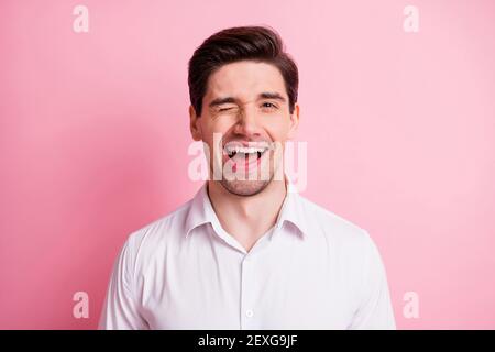 Portrait of cool guy blink wear white t-shirt isolated on vibrant ...