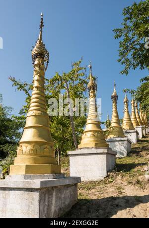 A line of traditional white Buddhist stupas (Shambhala Pagodas) in a ...