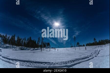 Full Moon lights over winter snowy forest with small hills, dark blue ...