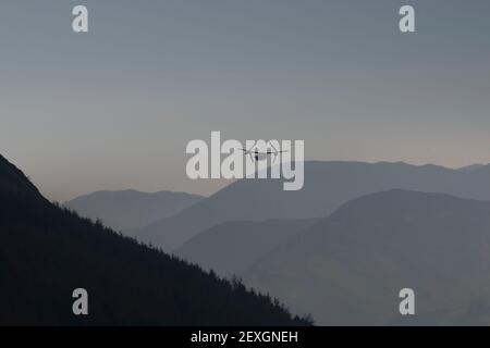 An RAF Osprey aircraft low flying over Ambleside, Lake District, UK ...