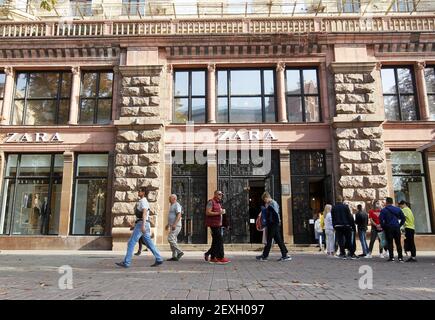 People walk past Zara logo outside its company store in downtown ...