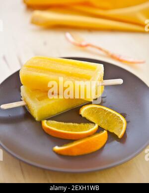 Homemade orange ice cream on a dark background with Ice cream spoon ...
