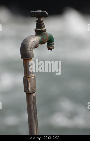 A vertical shot of a rusty metal water depth measurement tool in the ...