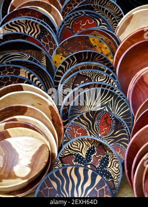 Close-up of a row of colourful plates on a wall shelf Stock Photo - Alamy