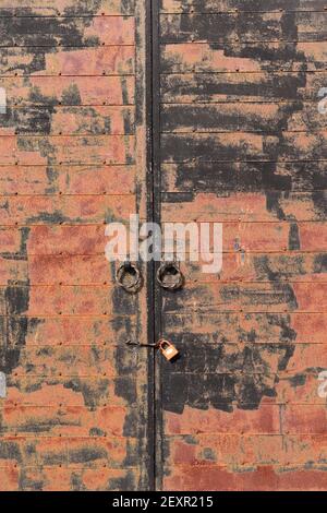 Old riveted iron door.Metal handles Stock Photo - Alamy
