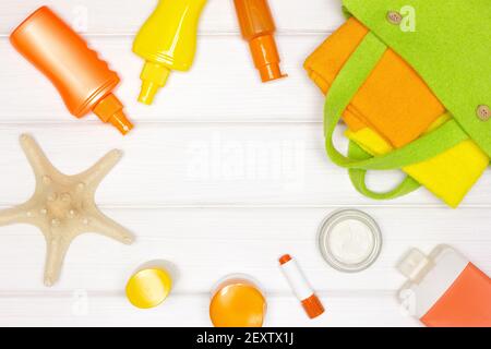 Face and body sunscreen products with towels, starfish and sunglasses ...
