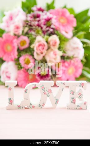 LOVE in front of colorful bouquet Stock Photo - Alamy