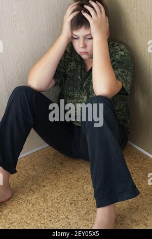 Sad Teenager sit in the Corner of the Old Building Stock Photo - Alamy
