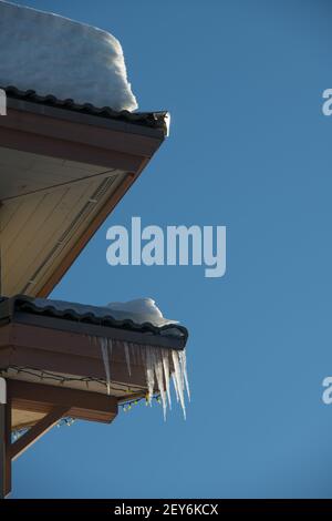 Icicles hang on the roof in winter. Selective focus. nature Stock Photo ...