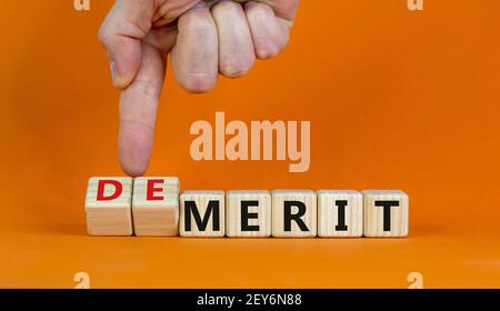 Demerit or merit symbol. Businessman turns wooden cubes and changes the ...