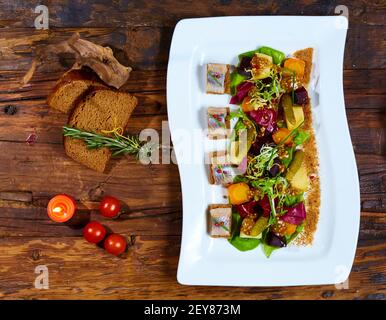 Canape from rye bread with herring slice Stock Photo - Alamy