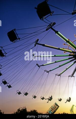 Amusement rides at a county fair at sunset Stock Photo - Alamy