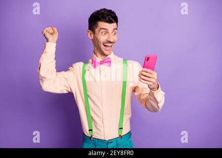 Photo of victorious young happy brunette woman raise fist win hold ...
