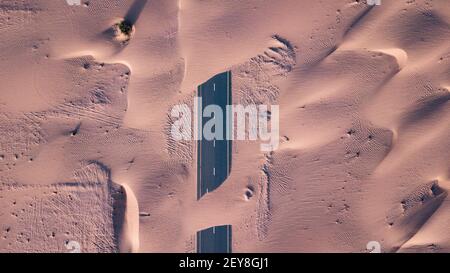 A highway covered by sand after a sandstorm in a desert in UAE Stock ...