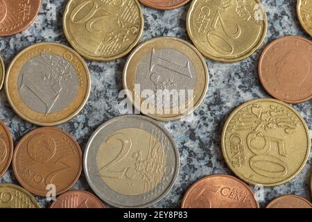 A high angle shot of different euro coins on a table Stock Photo - Alamy