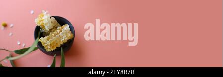Glass bowl with sweet honey, lemon slices and teapot on wooden board ...