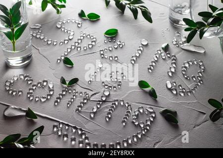 SPRING IS COMING text on letter board with bunny wooden figures and ...