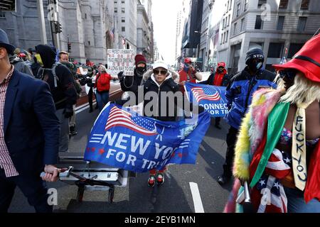 Trump supporters march towards Times Square holding up Trump and ...