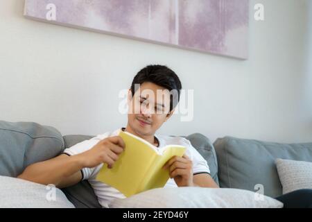 Asian man resting on sofa with fever and medicine at home Stock Photo ...